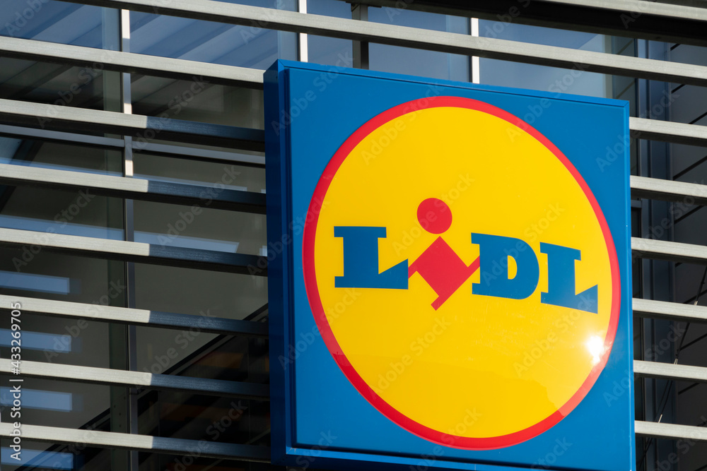 Lidl supermarket logo sign on modern store facade. Lidl is popular ...