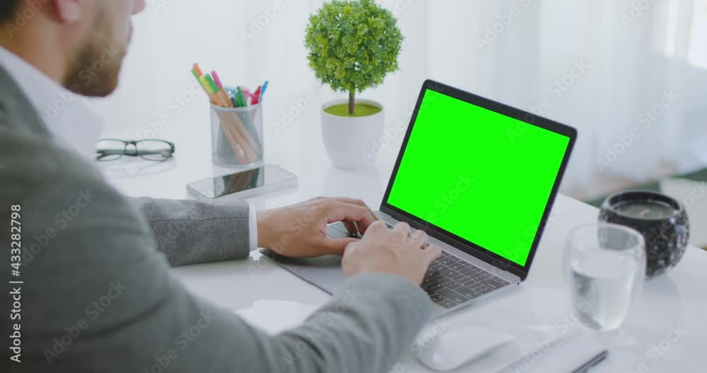 Sequence of shots of caucasian businessman typing on a laptop. Young ...