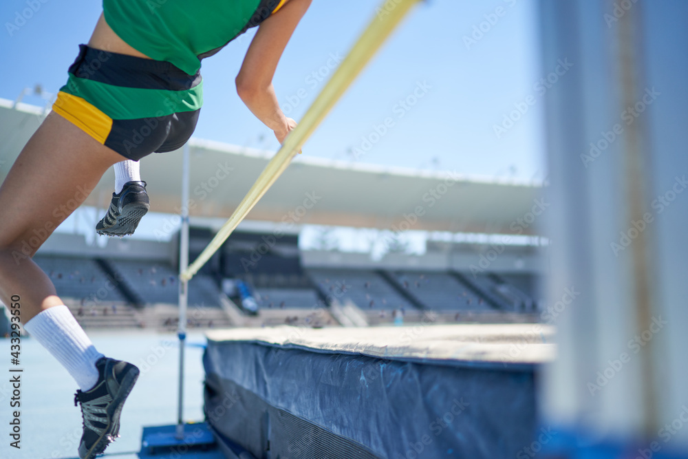 Female track and field athlete high jumping over pole Stock Photo ...
