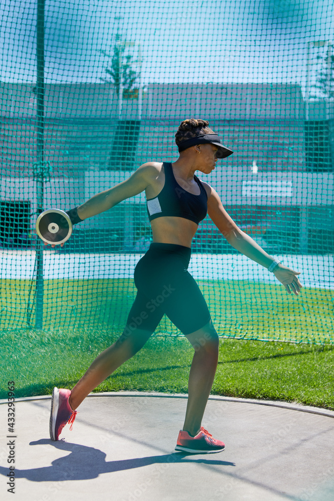 Female track and field athlete throwing discus Stock Photo | Adobe Stock