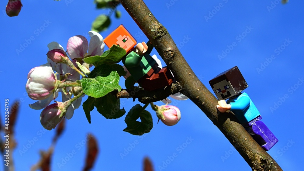 LEGO Minecraft figures of Steve and Alex climbing on flowering apple ...