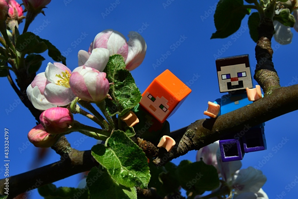 LEGO Minecraft figures of Alex and Steve climbing on flowering tree ...