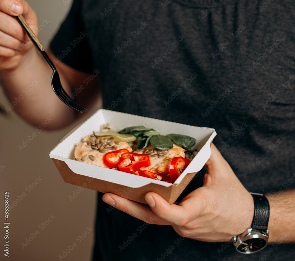 a man is going to eat healthy food in paper packaging. food in paper ...