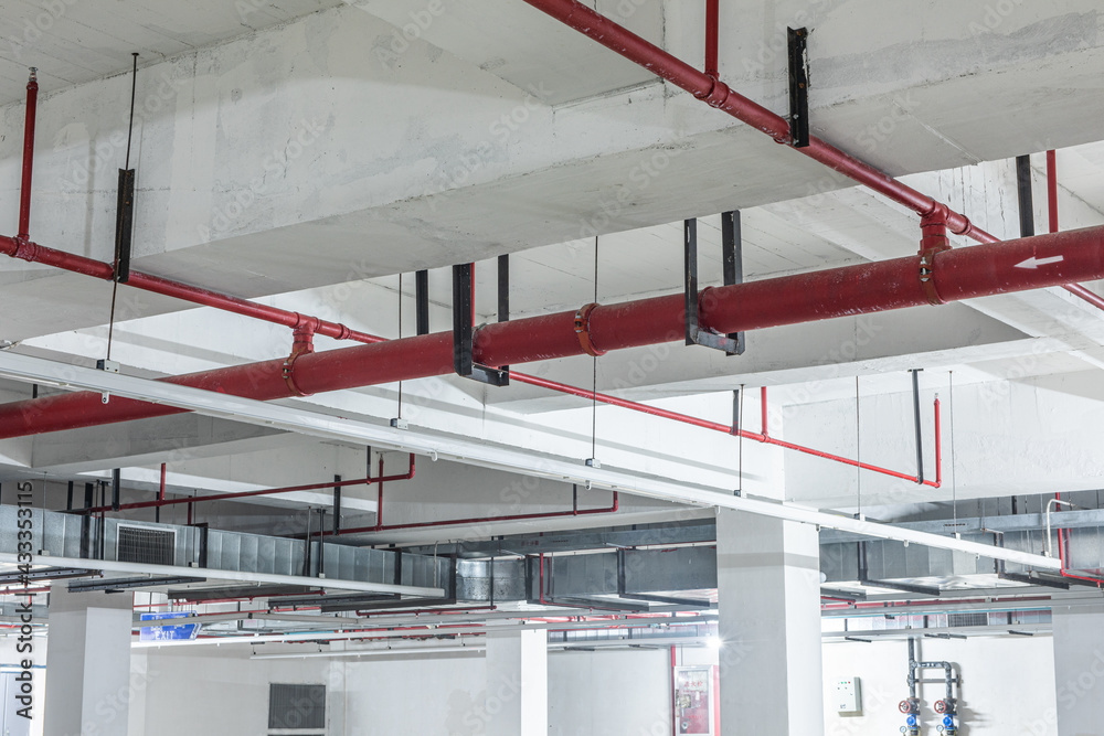 Fire protection sprinkler system with red pipes is placed to hanging ...