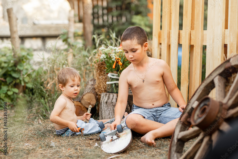 Smiling beautiful family on the backyard lawn. Childs expression. Two happy little boys playing ...