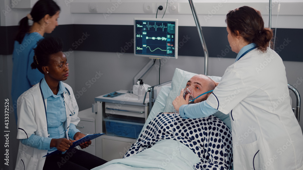 Afro american doctor discussing with sick man writing symptom sickness ...