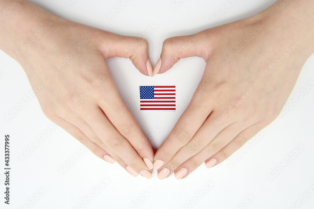 Female hands creating a heart, inside the US flag on a white background ...