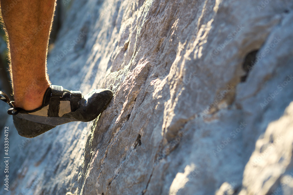 Climbing shoes on the climber's foot rest the toe on the rock. Extreme ...