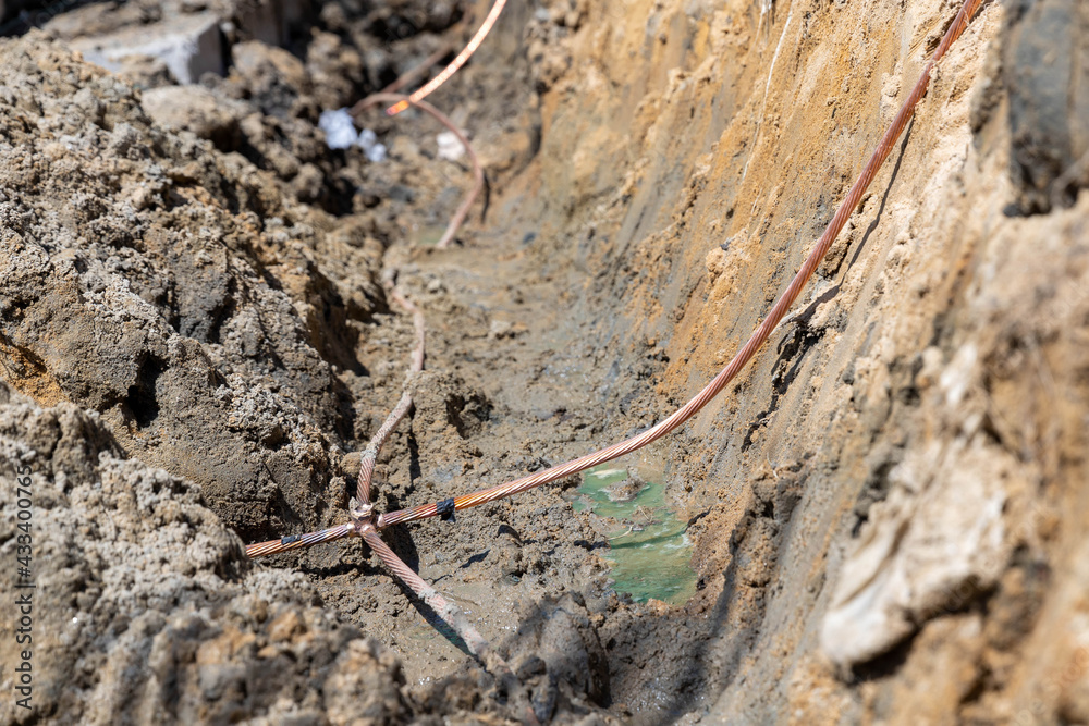 Several copper wires are connected to conductors to the ground rod of ...