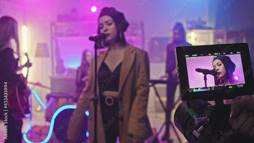 Medium slowmo of camera filming closeup of attractive lead singer ...