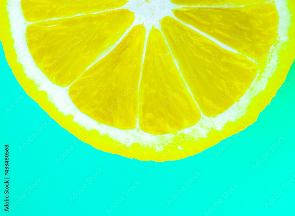 Close up photo of lemon texture on the blue background. Fruit cut in ...