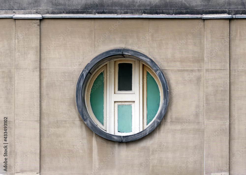 Round porthole window. The toilet window is painted green. The facade ...