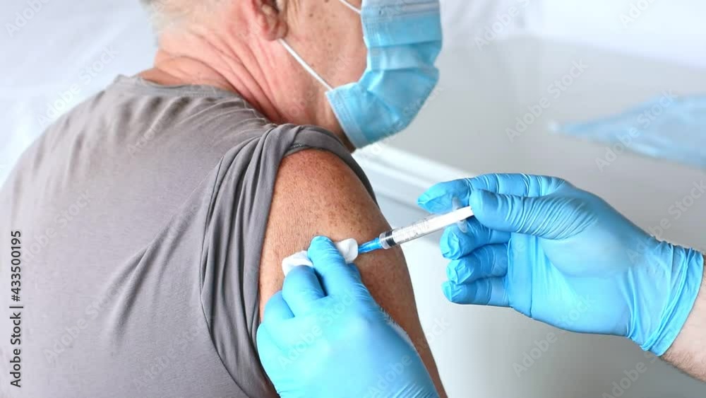 Elderly Man in Face Mask getting Covid Vaccine. Doctor giving Injection ...