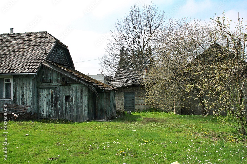 old rural buildings, wooden house, outbuildings, farm, green grass in ...