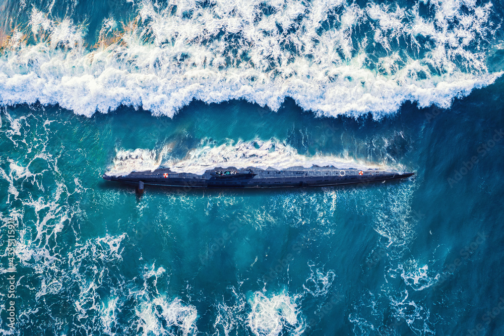 Combat military nuclear diesel electric submarine on background of blue ...