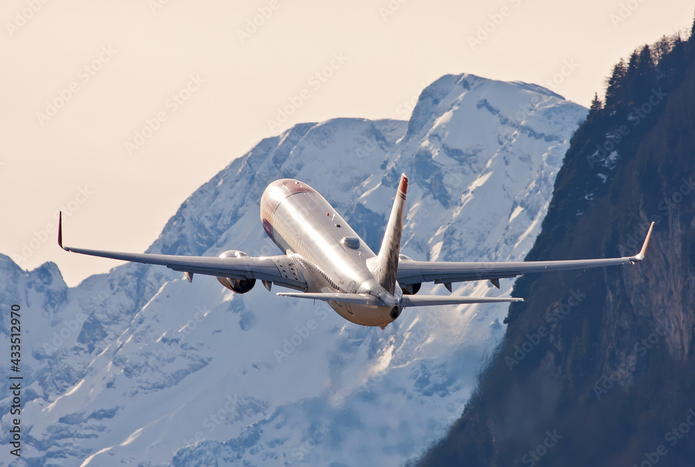 Norwegian Boeing 737 taking off in front of mountains Stock Photo ...