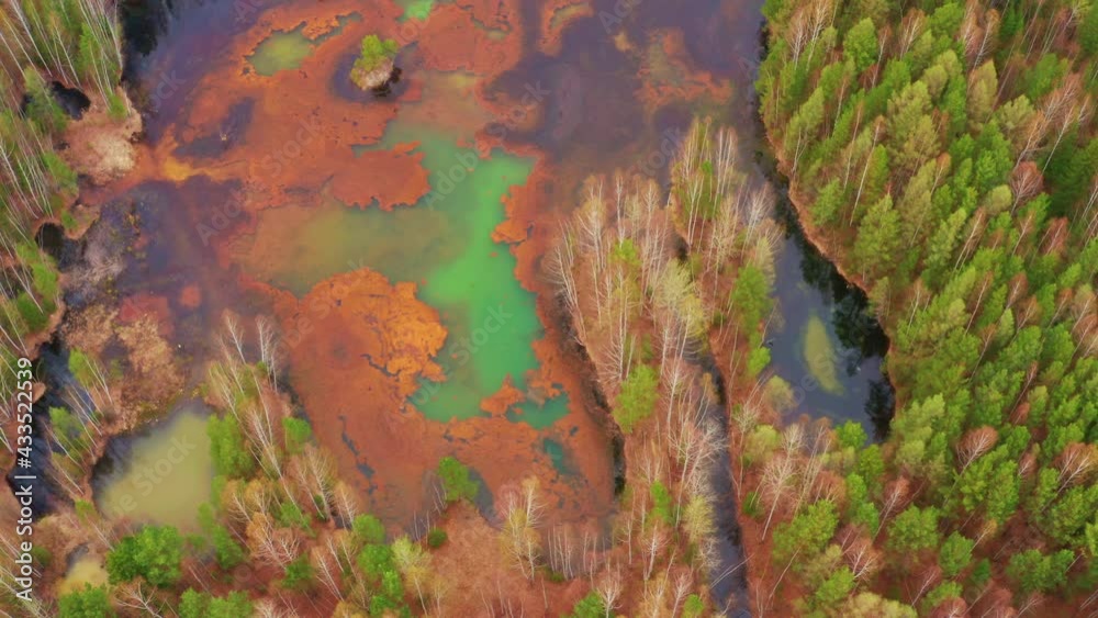 Beautiful toxic lake in the middle of a green forest. Industrial plant ...