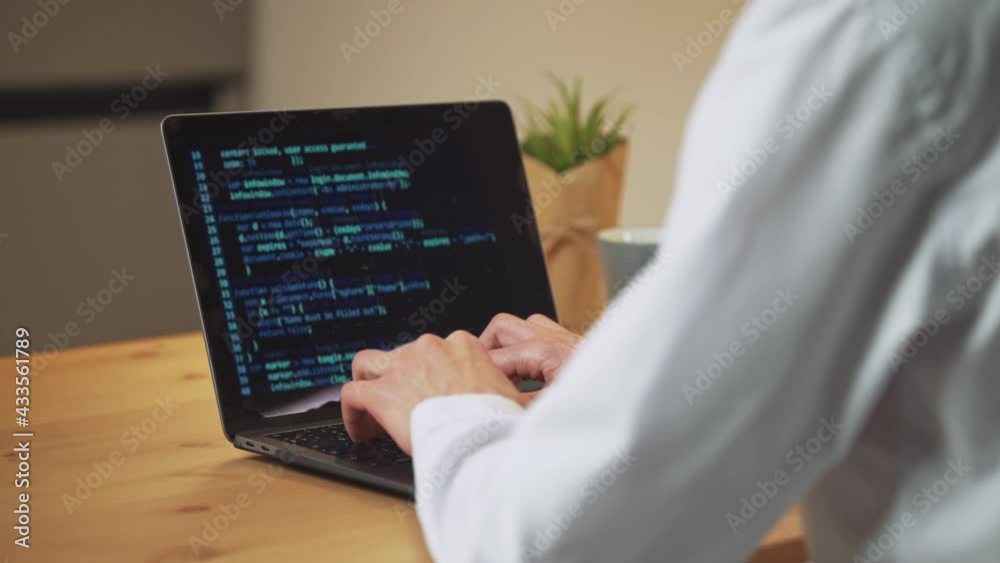 Vidéo Stock Male programmer is working on creating software, typing ...