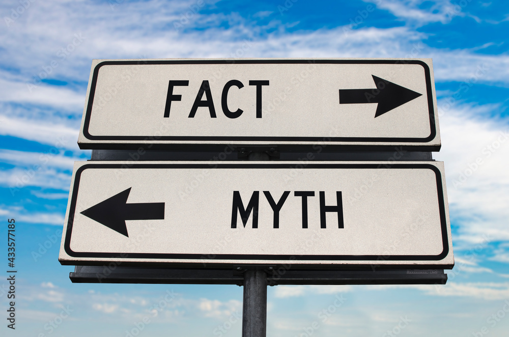 Fact versus myth road sign with two arrows on blue sky background ...