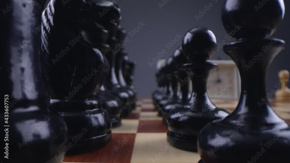 Look between the chess pieces. Two chess players man and woman play ...