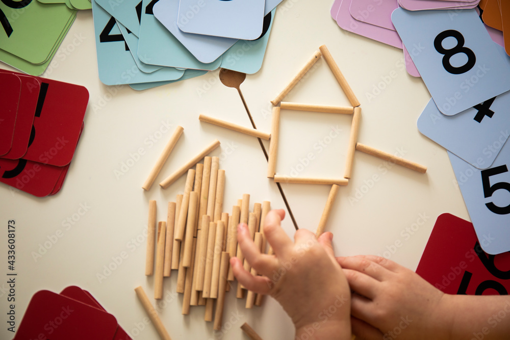 Little caucasian girl studying numbers and math in the classroom ...