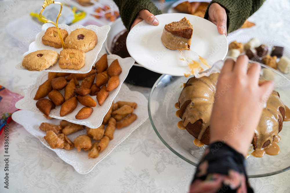 Eid dessert table with a selection of traditional snacks and cake Stock ...