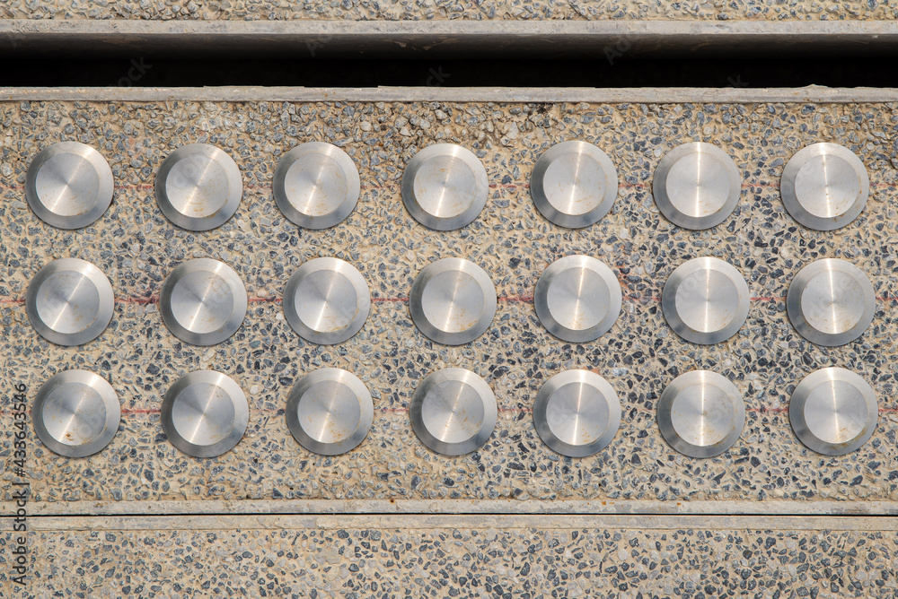 Stainless steel metal pins in a row on the terrazzo floor to slip. top ...