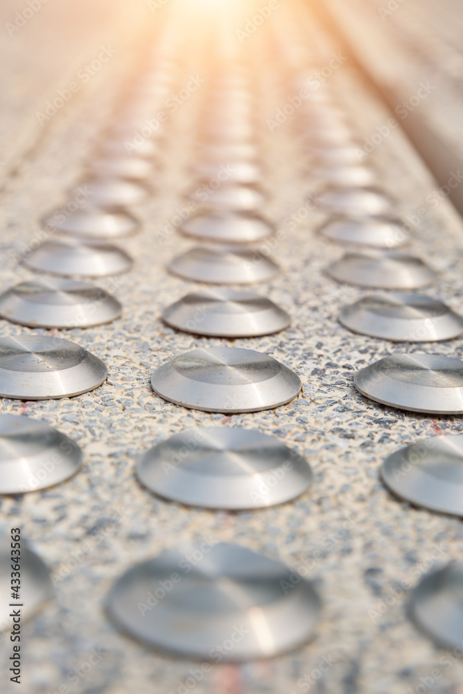 Stainless steel metal pins in a row on the terrazzo floor to slip. top ...