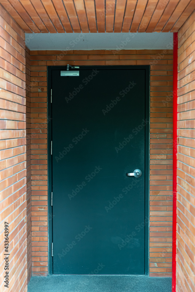 Building Emergency Exit with Exit Sign. Fire exit doorway made by brick ...