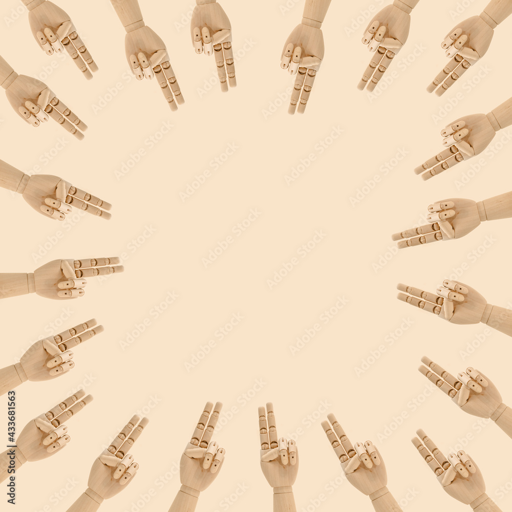 From above of composition of wooden hands with index and middle finger ...