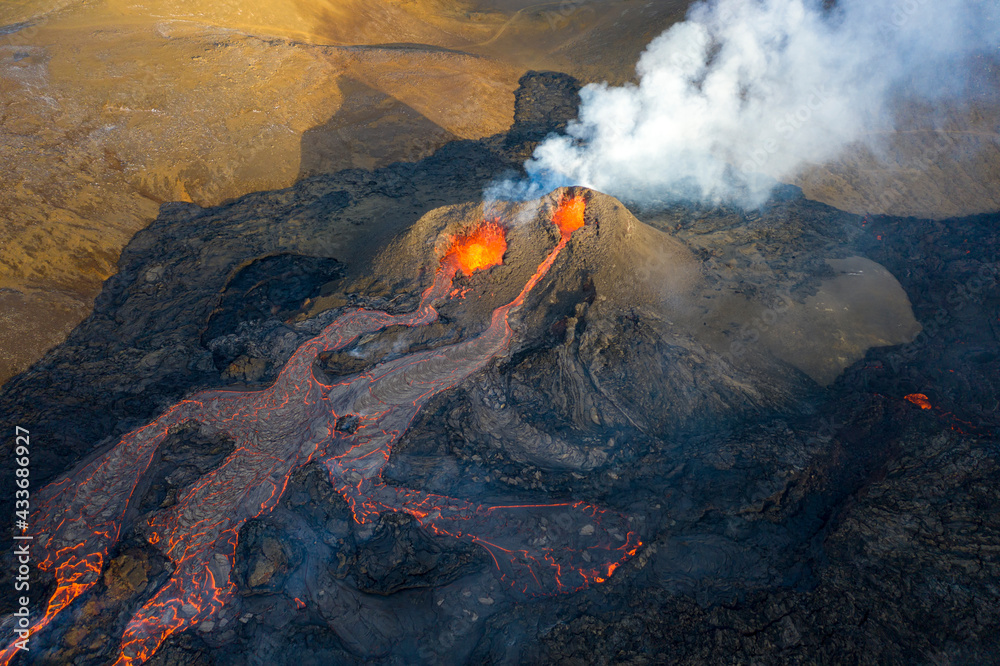 From above magma sparks out of the volcano hole and run like rivers of ...