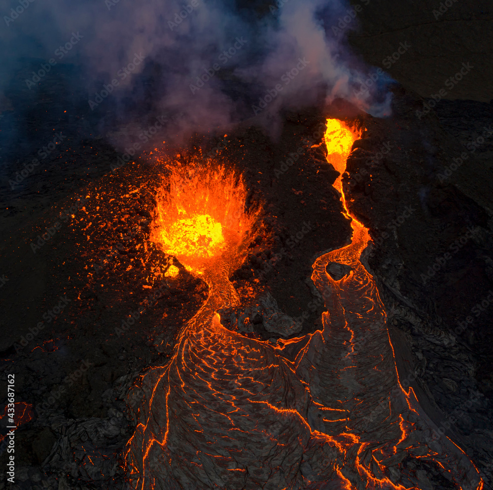 From above magma sparks out of the volcano hole and run like rivers of ...