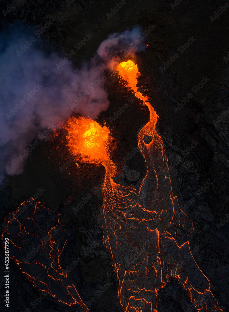From above magma sparks out of the volcano hole and run like rivers of ...