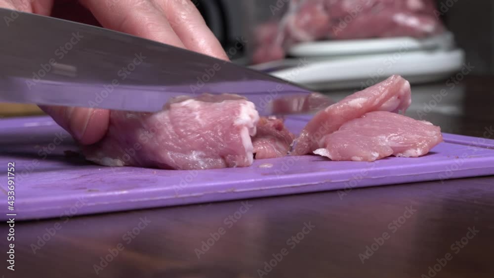 Cut pork or beef meat with a knife on the table close-up. Preparation ...