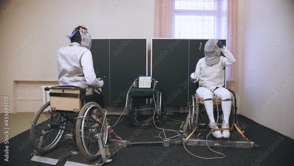 disabled athlete. fencing. sparring in fencing duel of two wheelchair ...