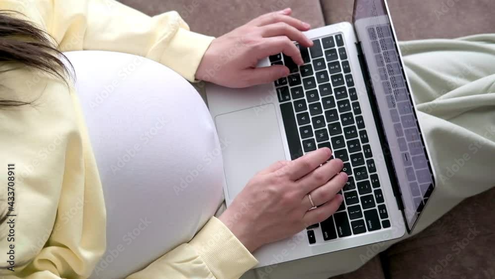 4k Top view Expectant mother working remotely online from home. Close ...