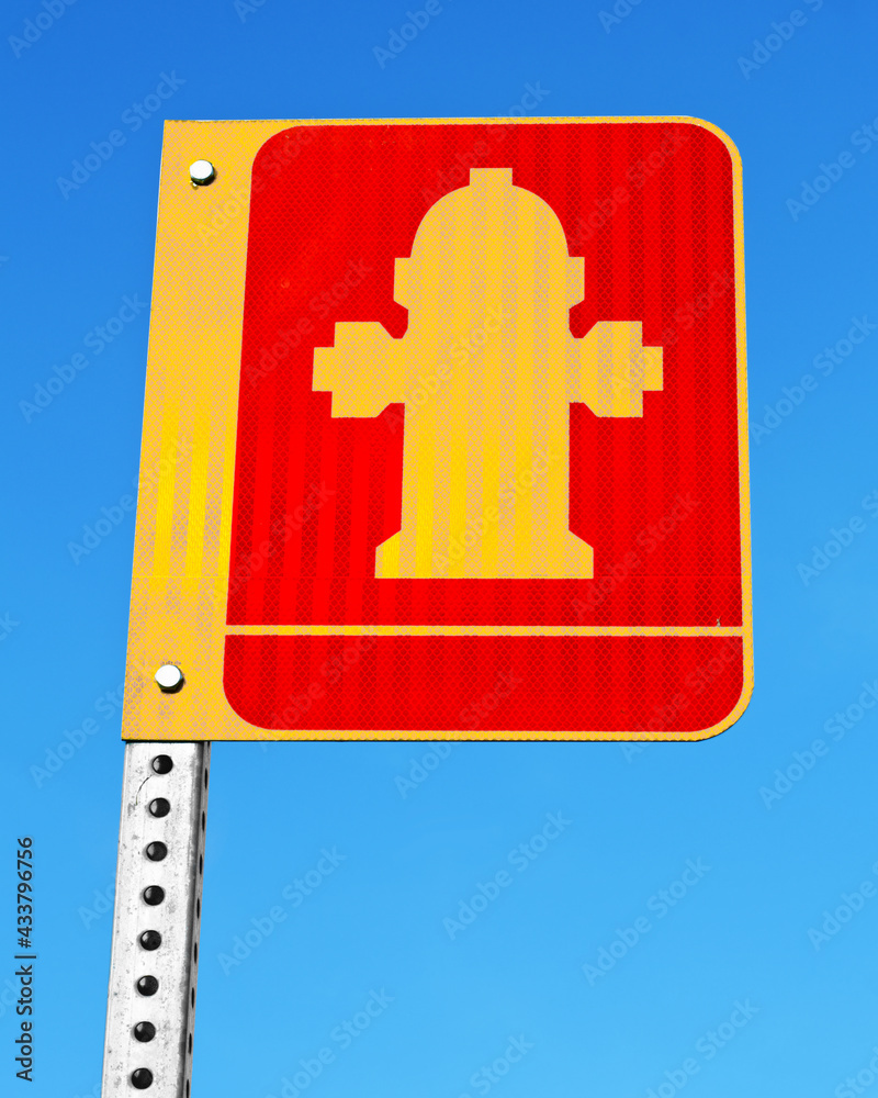Red and yellow fire hydrant sign and blue sky Stock Photo | Adobe Stock