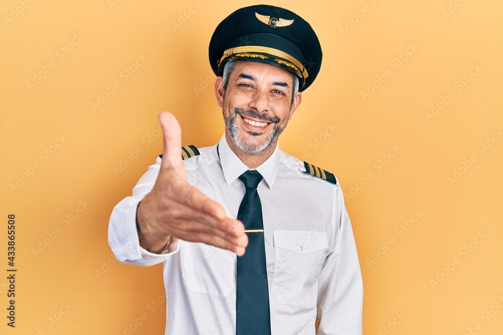 Handsome middle age man with grey hair wearing airplane pilot uniform ...