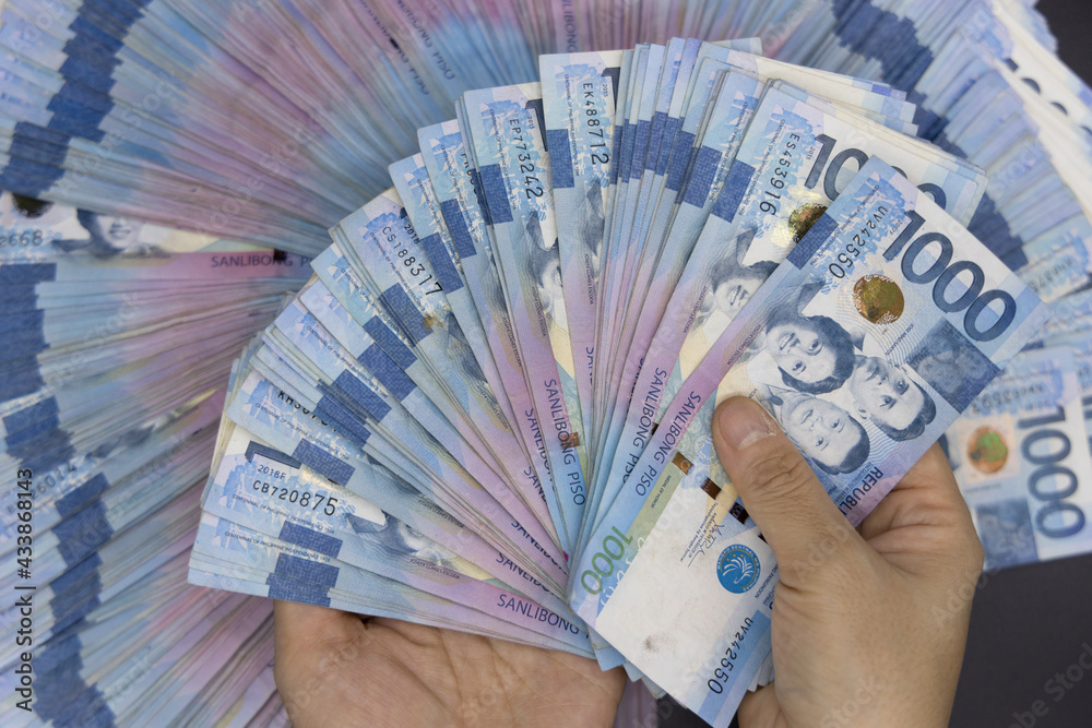 A pile of one thousand Philippines peso banknotes. Cash of Thousand ...