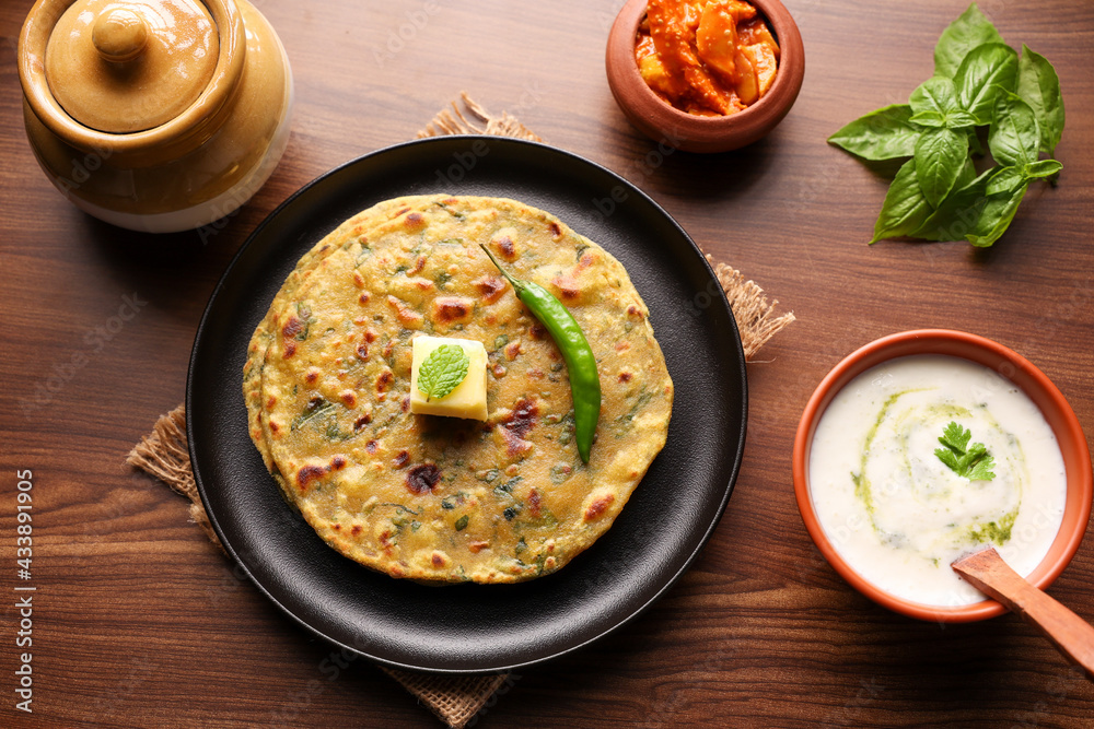 Palak paratha butter on spinach paratha , parantha ,chapati Indian ...