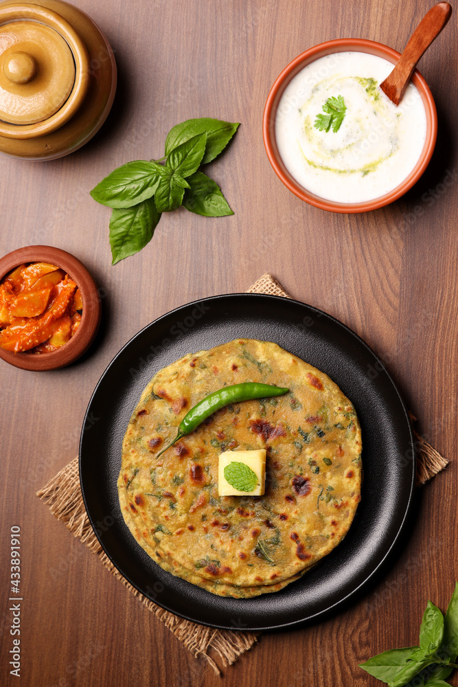 Palak paratha butter on spinach paratha , parantha ,chapati Indian ...