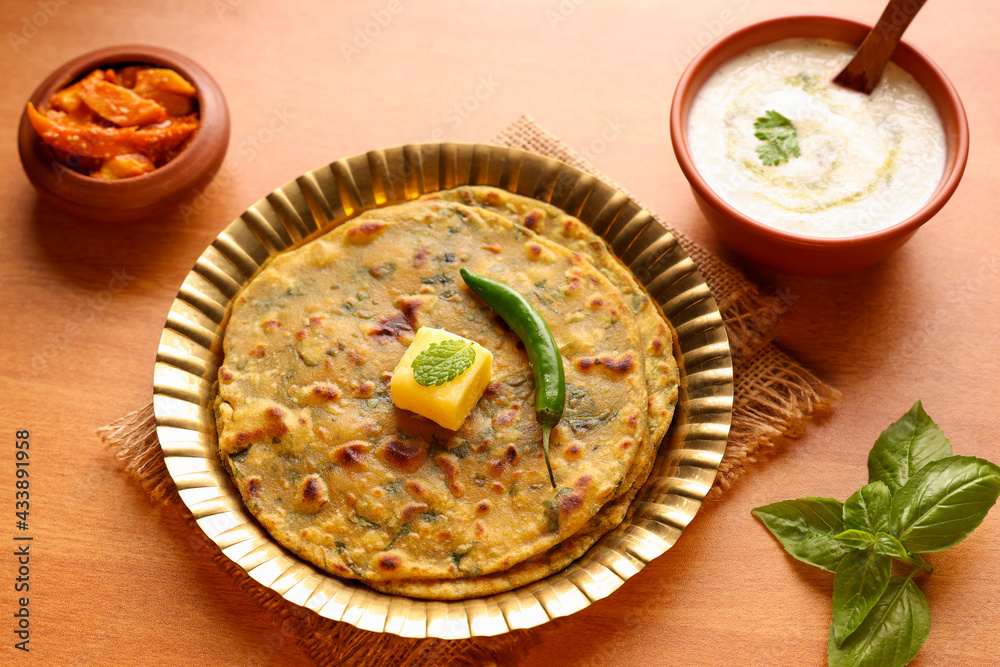 Palak paratha butter on spinach paratha , parantha ,chapati Indian ...