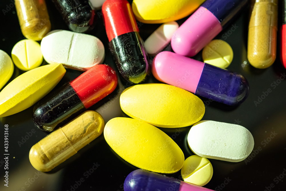 Pharmaceutical medicine pills in both tablets and capsules with the ...
