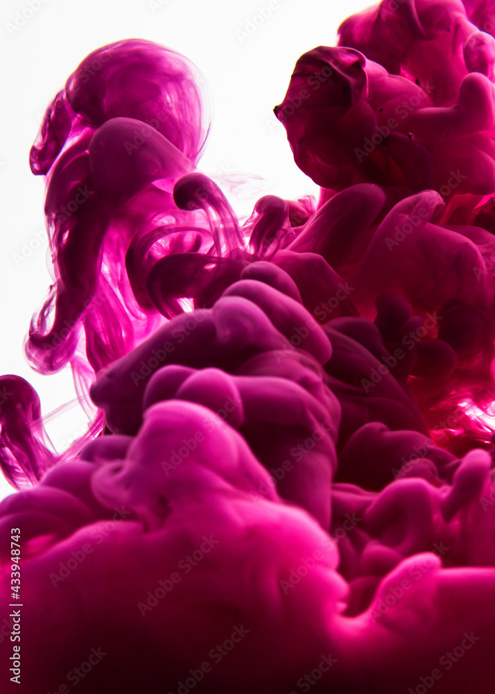 Color drop in water, photographed in motion. pink ink in water isolated ...