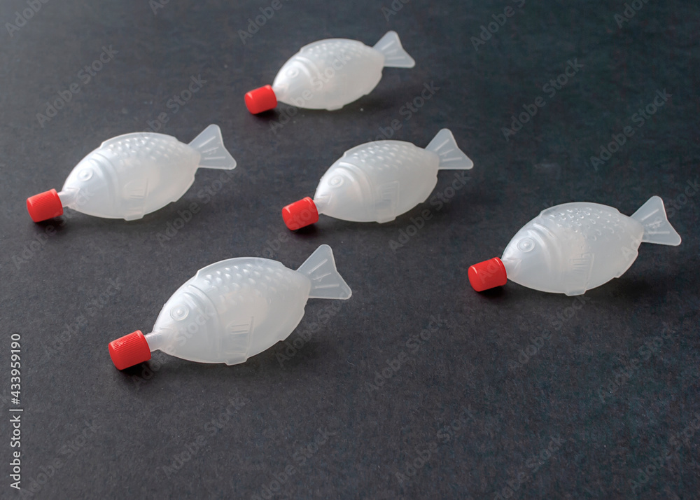 Plastic fish shoal. Plastic fish container from soy sauce fo sushi on ...