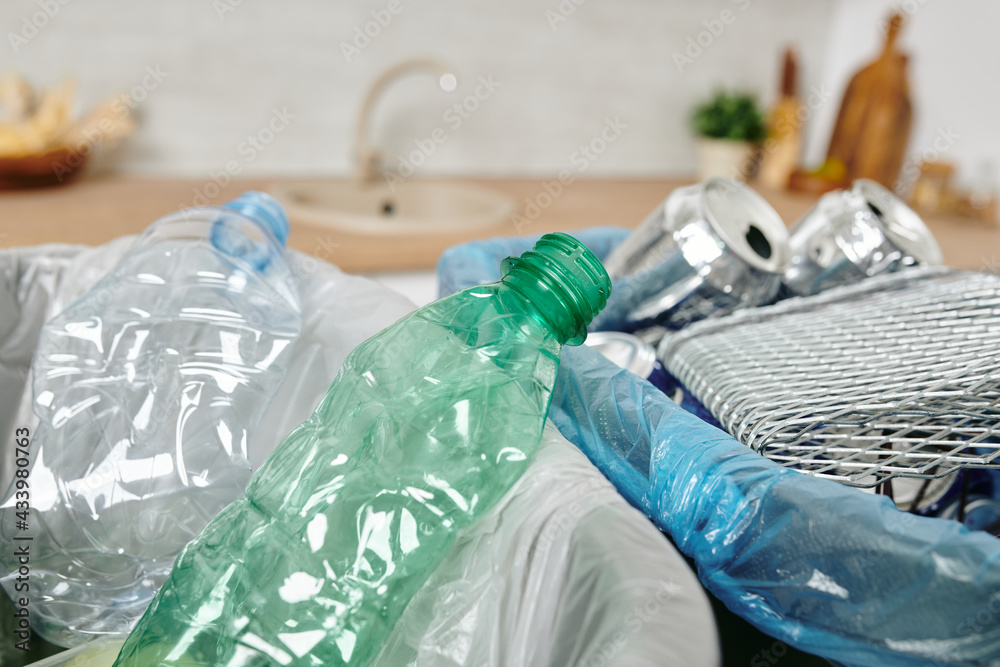 Trash bins with empty cans, plastic bottles and other waste in home ...