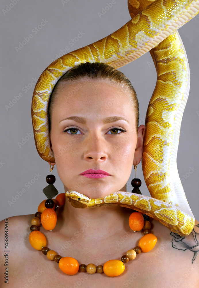 A beautiful young woman poses nude for the camera. Her earrings and ...