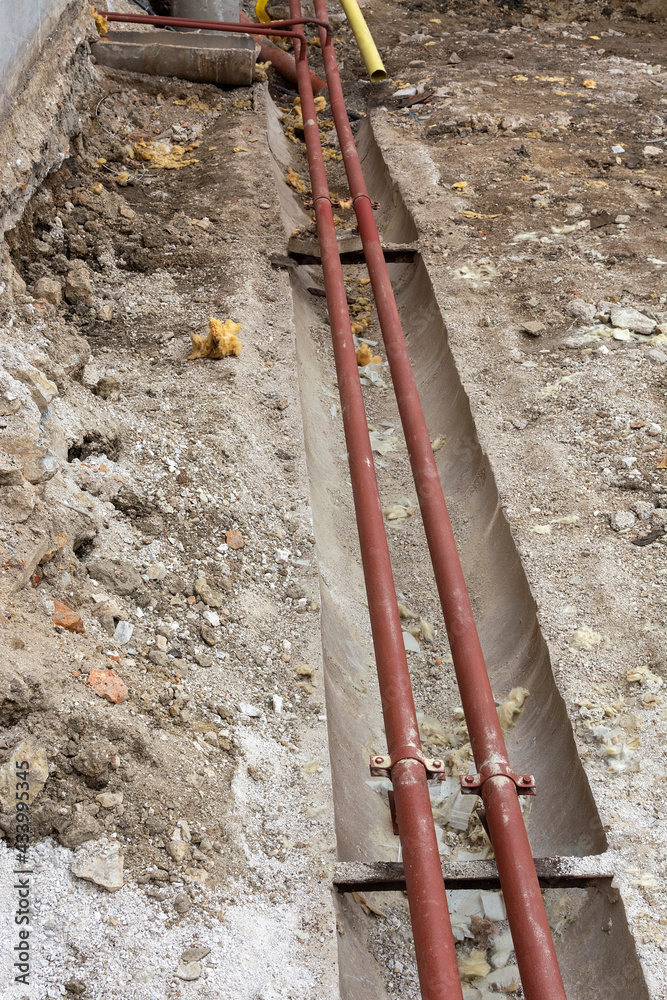 the flow and return steel pipes are placed underground into concrete ...