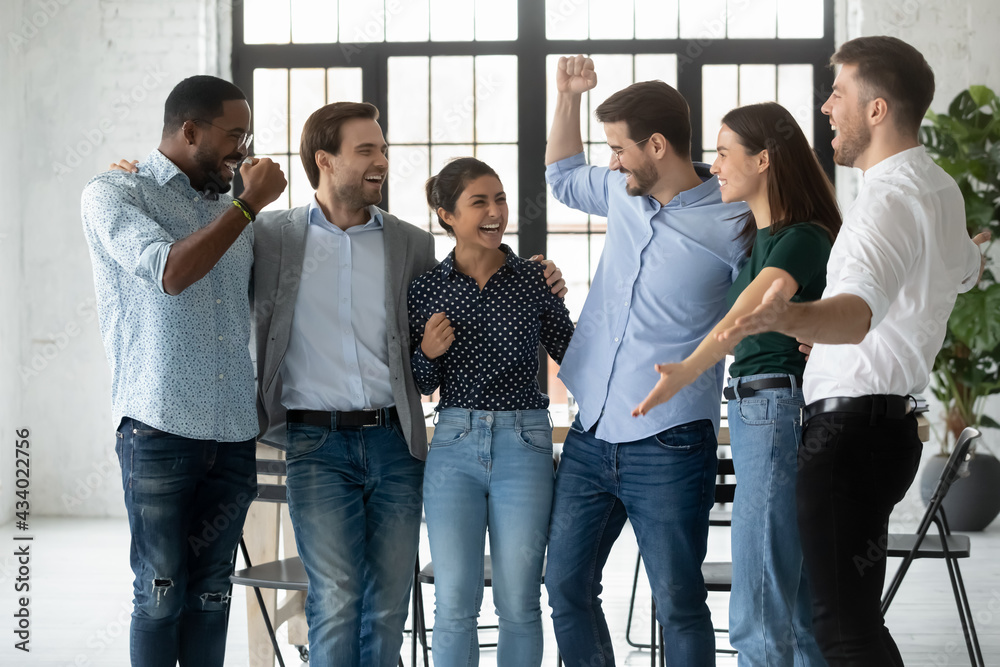 Excited motivated colleagues shouting for joy and celebrating team ...