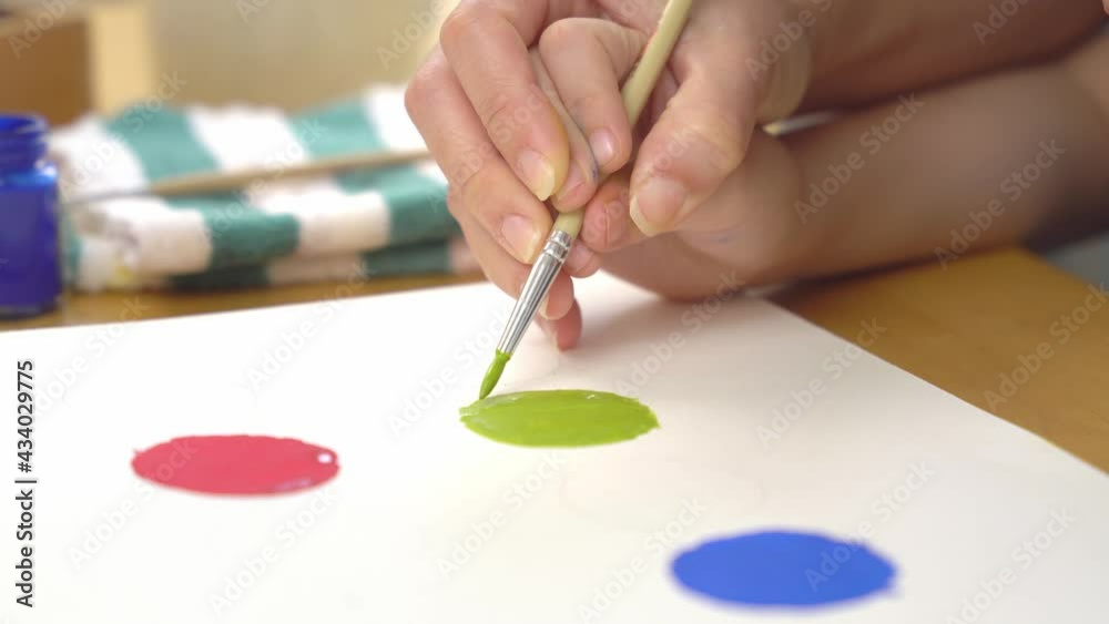 Color mixing theory in homeschool concept. Close up of Asian mother's ...